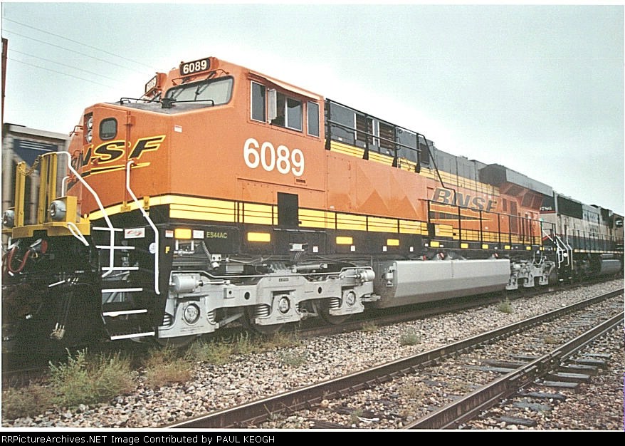 BNSF 6089 rear DPU next to BNSF 6102 on a cold blustery rainy day in Denver, Co.